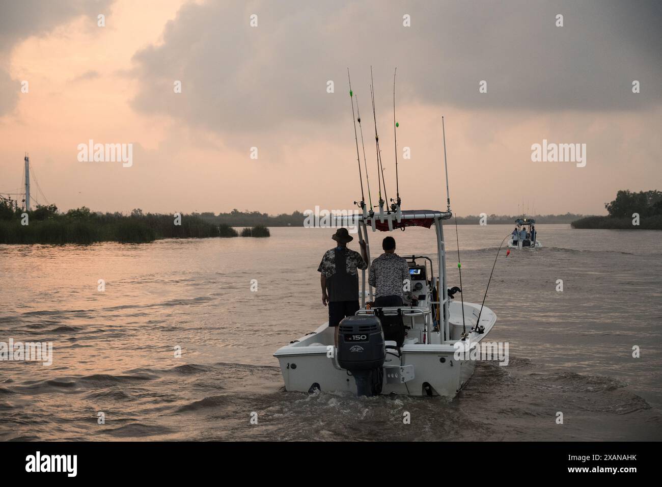 Anglers aboard a fishing boat near offshore oil rigs in the Gulf of ...
