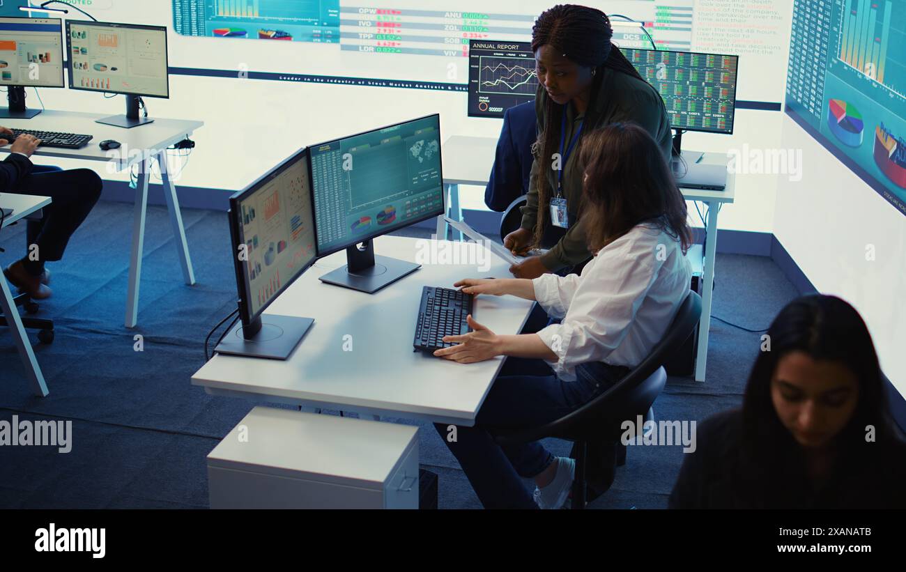 Business associates comparing key performance indicators within the ...