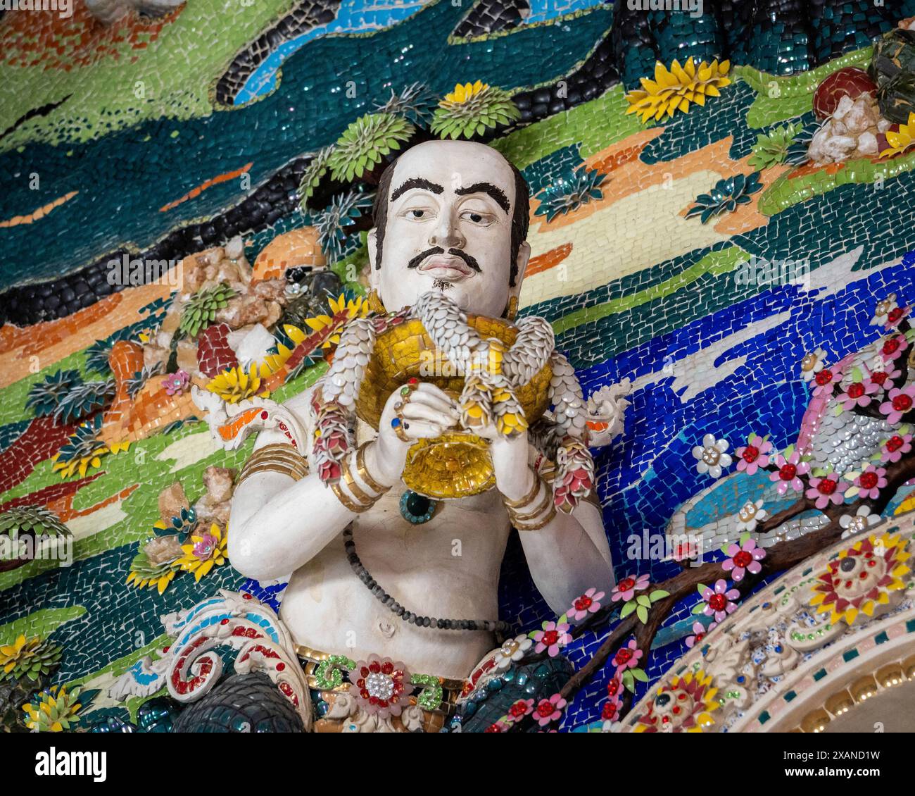 A close-up of a man sculpture with mosaics, with an intrigues face, at ...