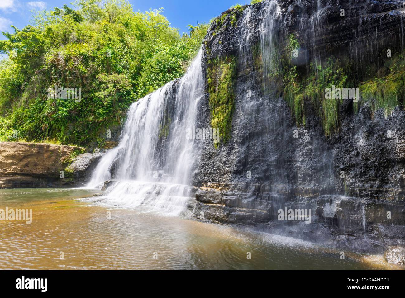 Landscape of Talofofo Waterfall with jungle and blue sky in the ...