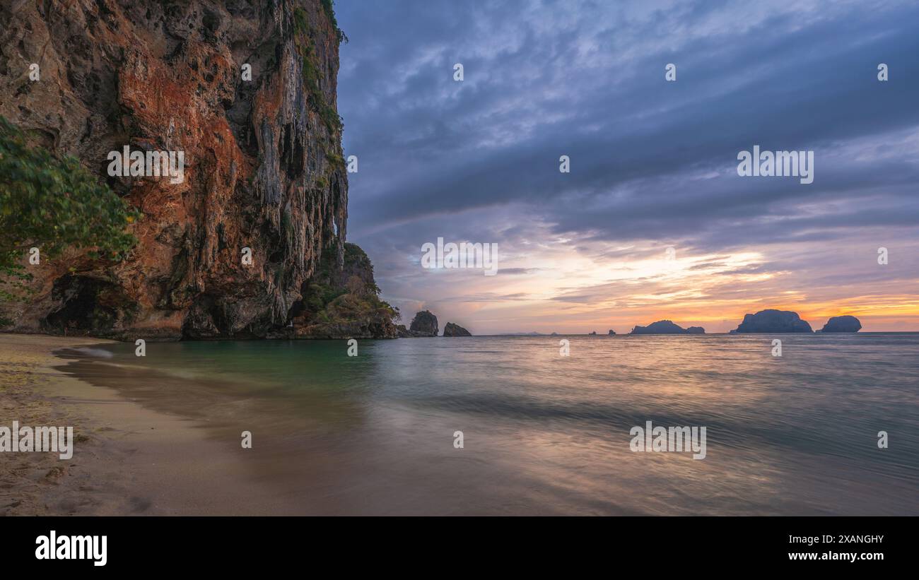 beautiful sunset at the princess cave beach on railay beach in thailand ...