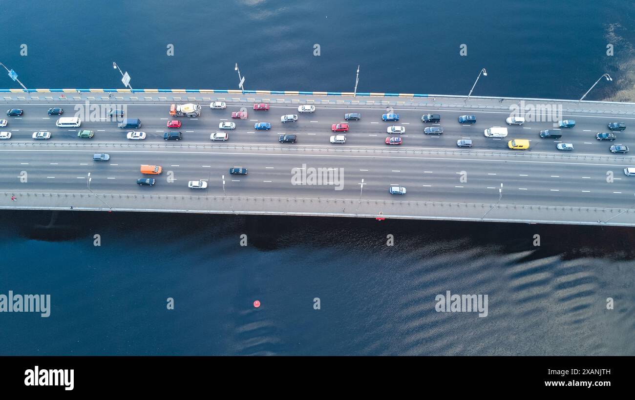 Aerial drone view of bridge road automobile traffic of many cars from ...