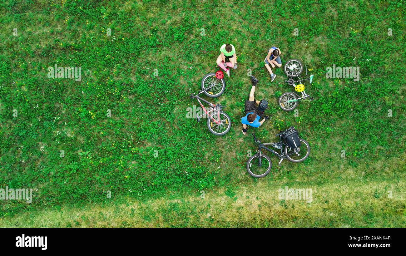Family cycling on bikes aerial view from above, happy active parents ...