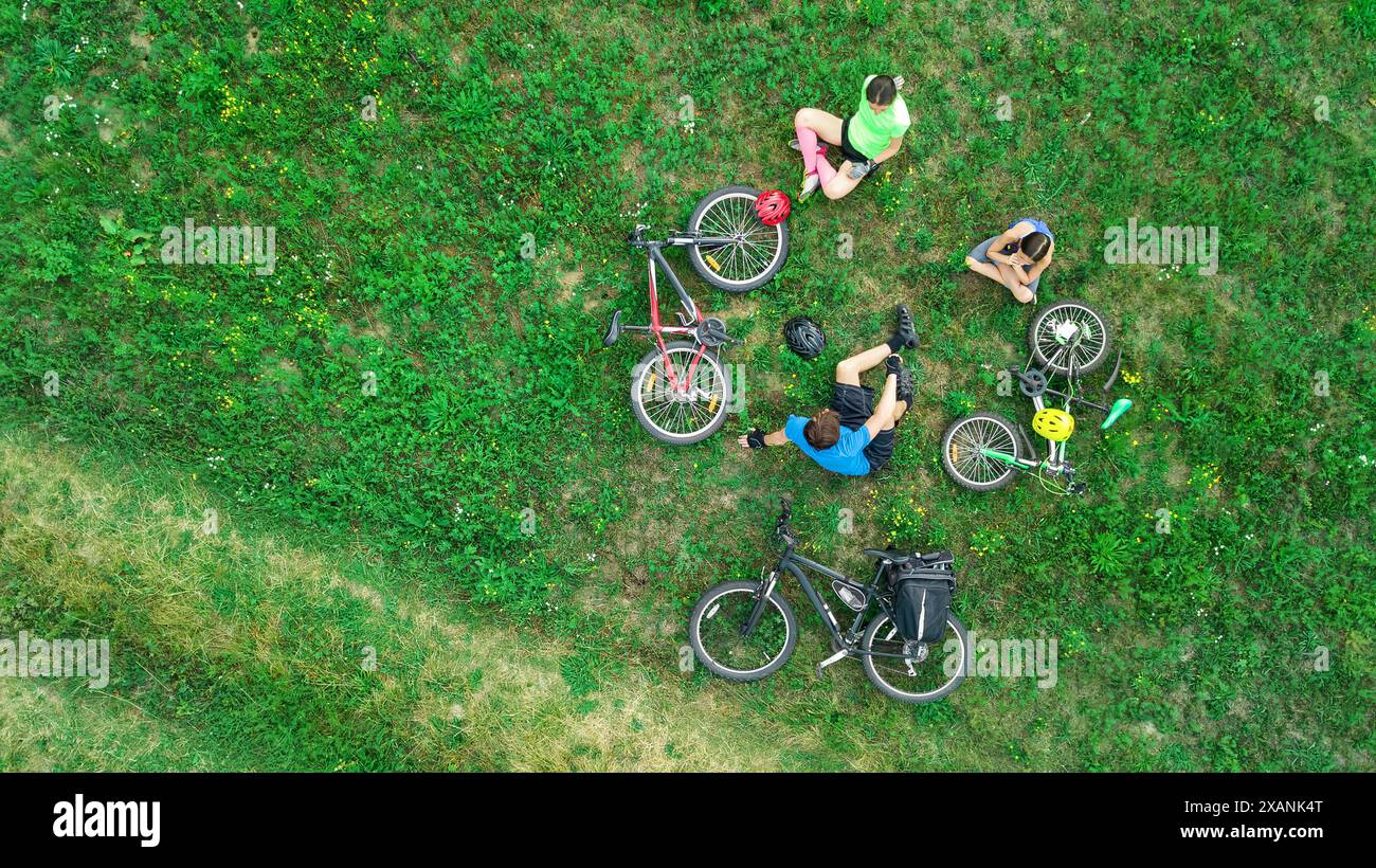 Family cycling on bikes aerial view from above, happy active parents ...