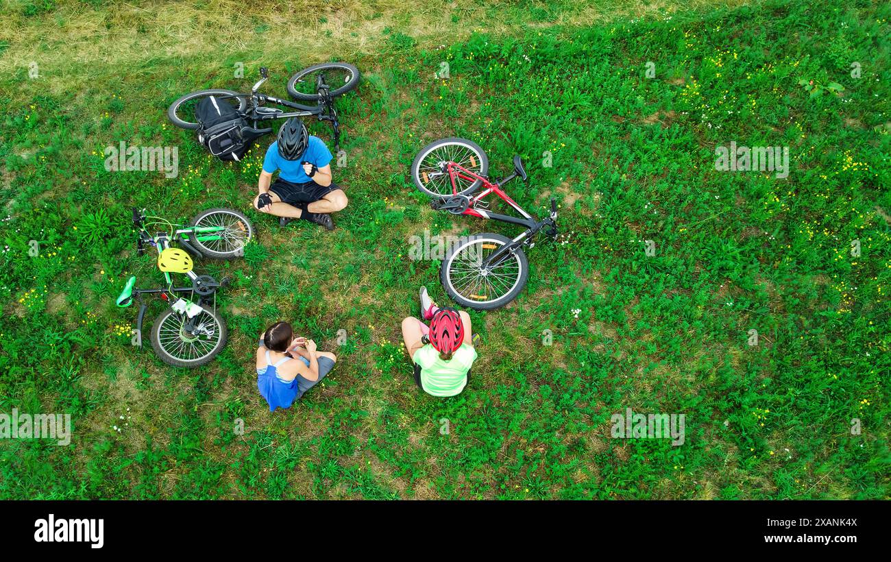 Family cycling on bikes aerial view from above, happy active parents ...