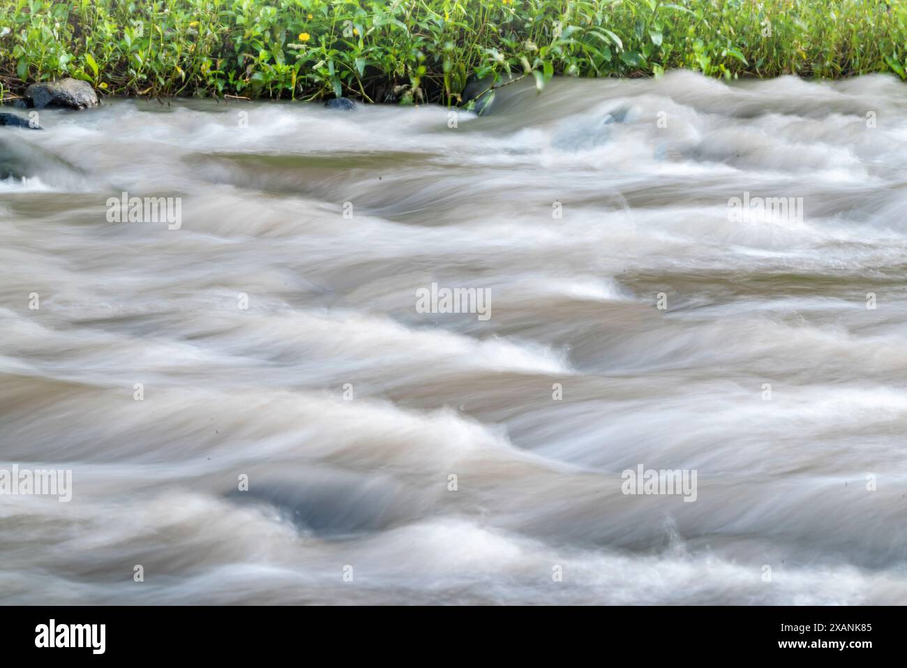 The water is flowing and has a light color. The water is calm and ...