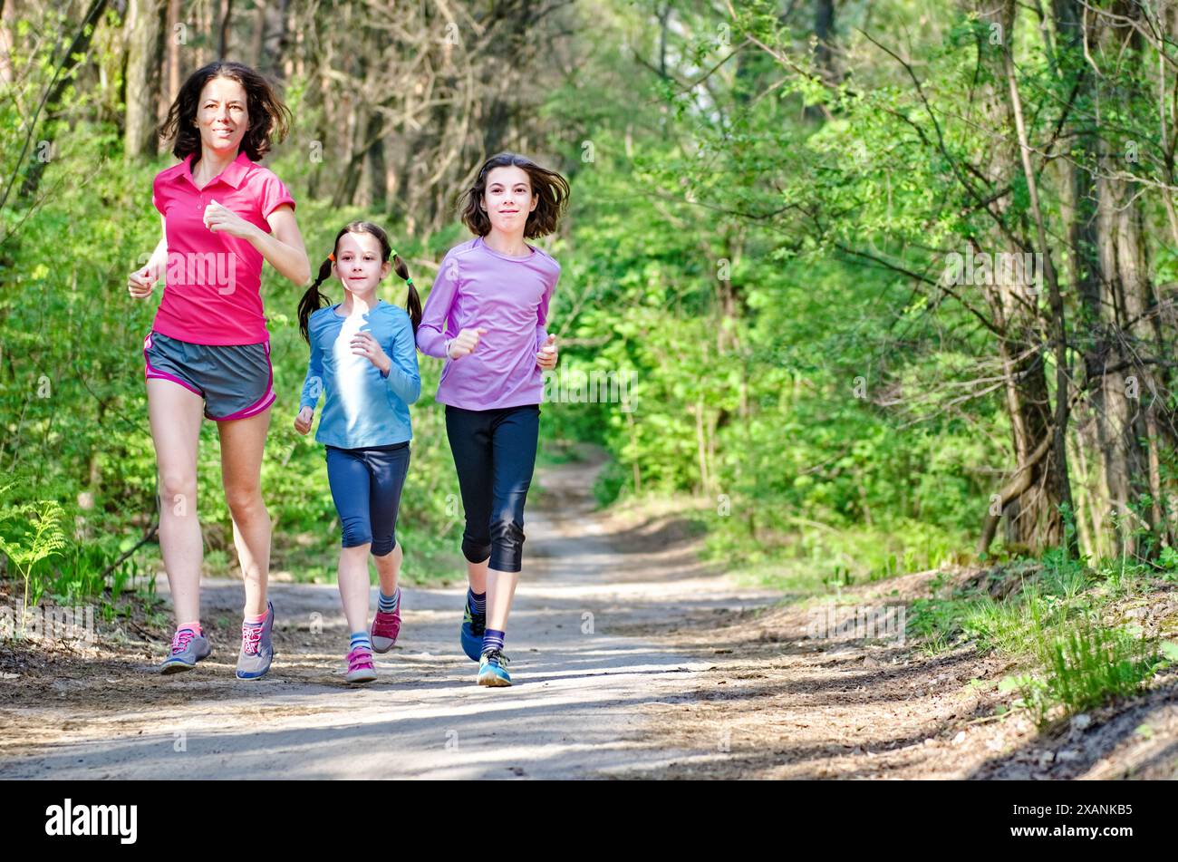 Family running, happy active mother and kids jogging outdoors, run with ...