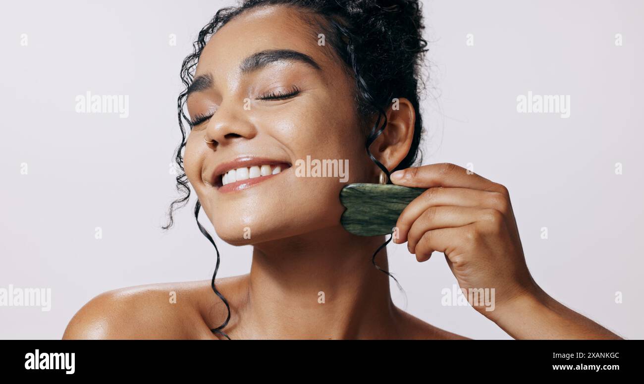 Skincare, smile and woman with gua sha stone for wellness, dermatology ...