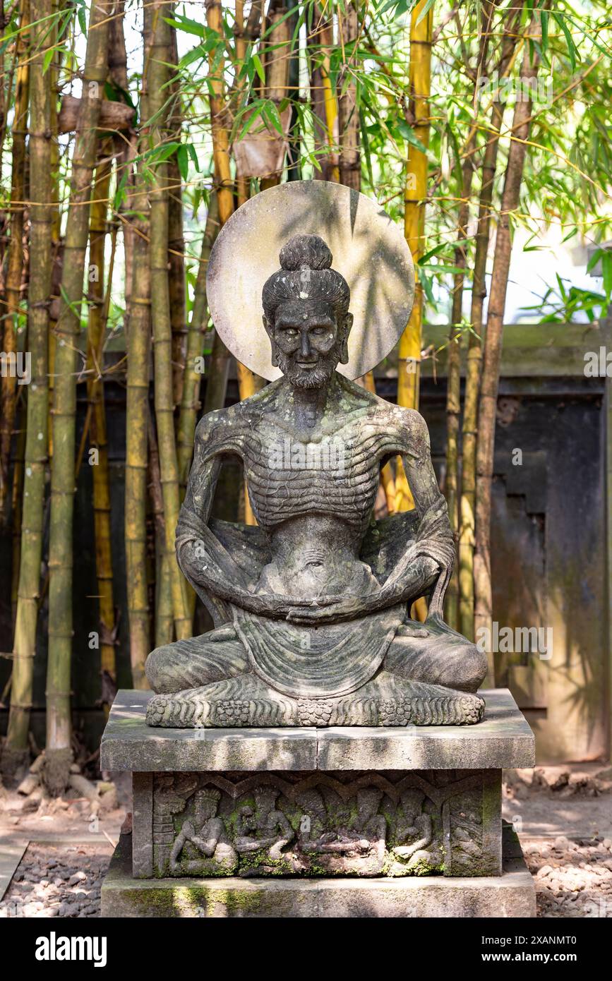 Candi Mendut, Magelang, Indonesia - May, 22th 2024. A statue of a man ...