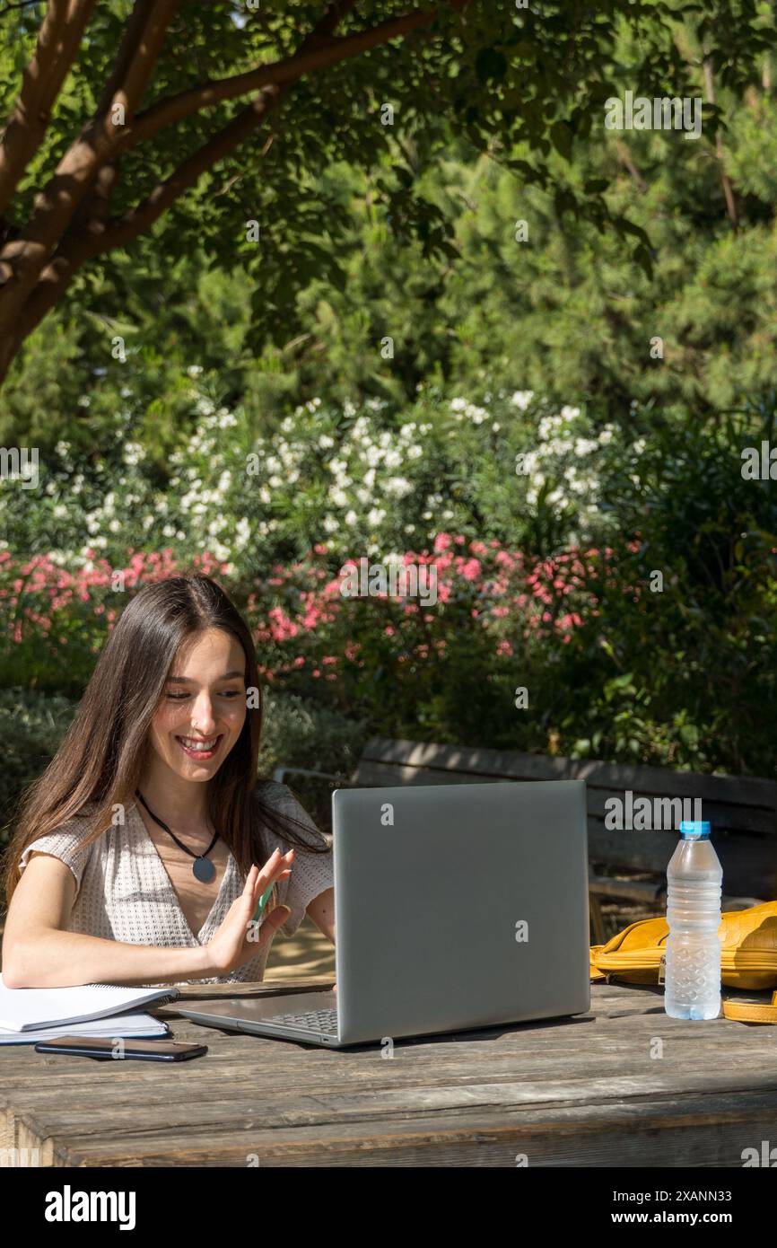College girl at beginning of classes, interacting with her laptop on ...