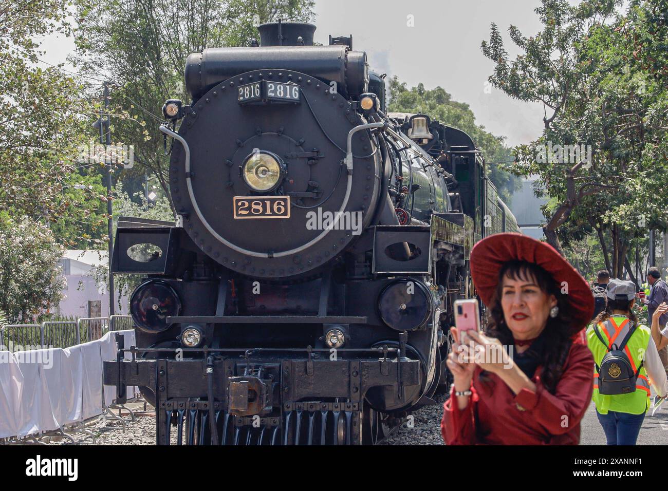 Final Spike Steam Tour A woman wearing a dress from the 1930s. takes a ...