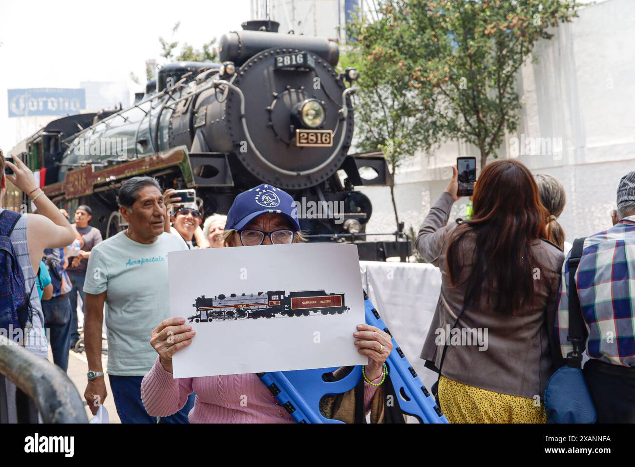 Final Spike Steam Tour A woman holds a drawing of a locomotive front ...