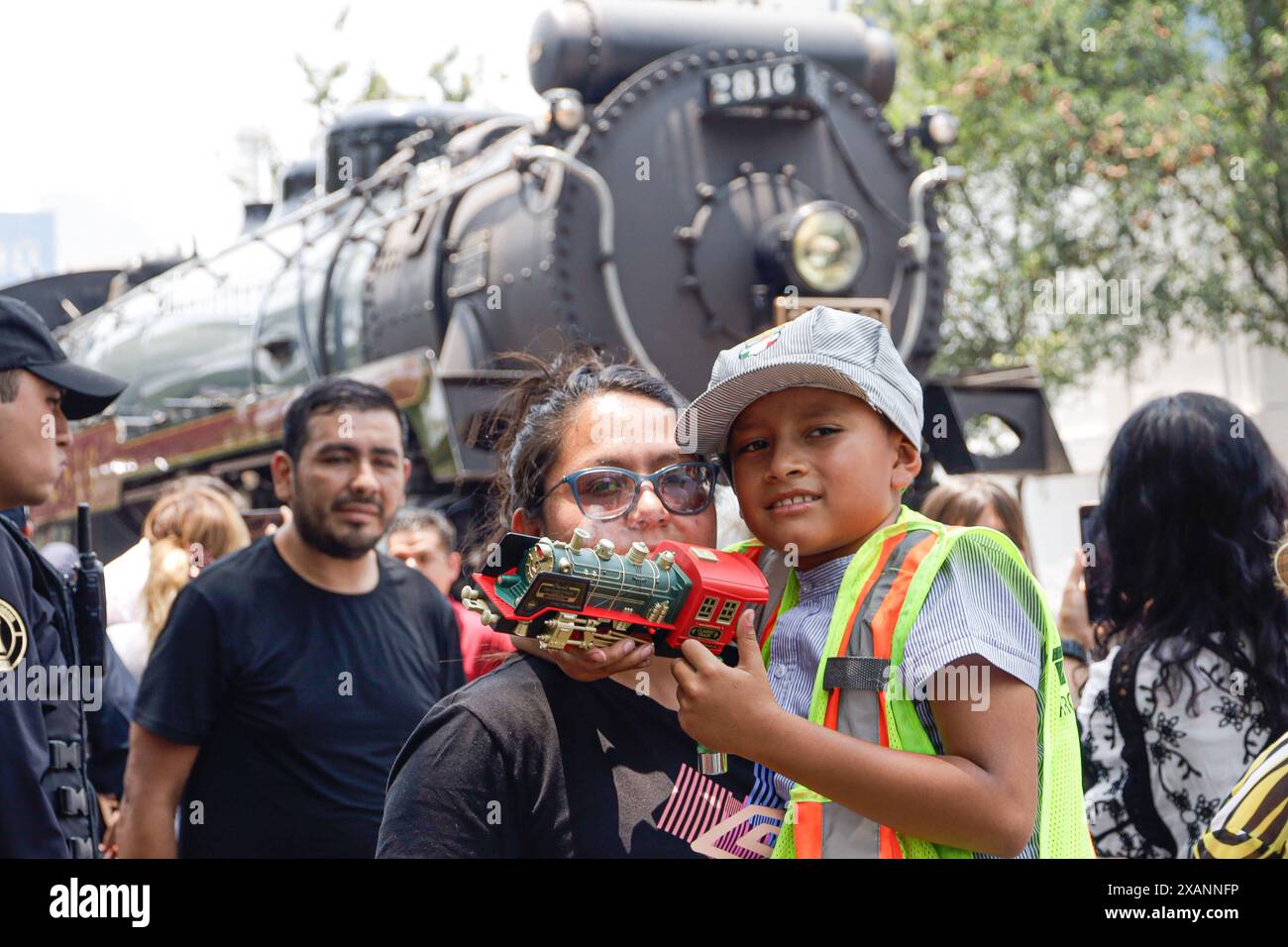 Final Spike Steam Tour A child holds a toy of a locomotive front the ...