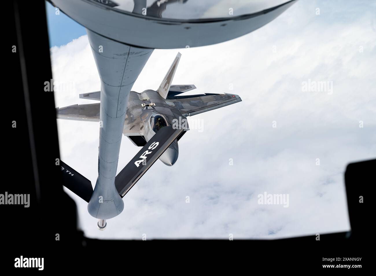 A U.S. Air Force F-22A Raptor operated by the 199th and 19th Fighter Squadrons approaches a KC ...