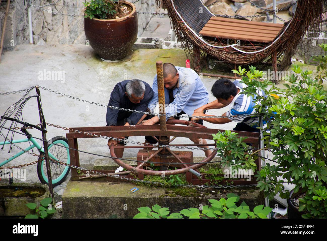 Local chinese people worker working push pull open close floodgate of ...