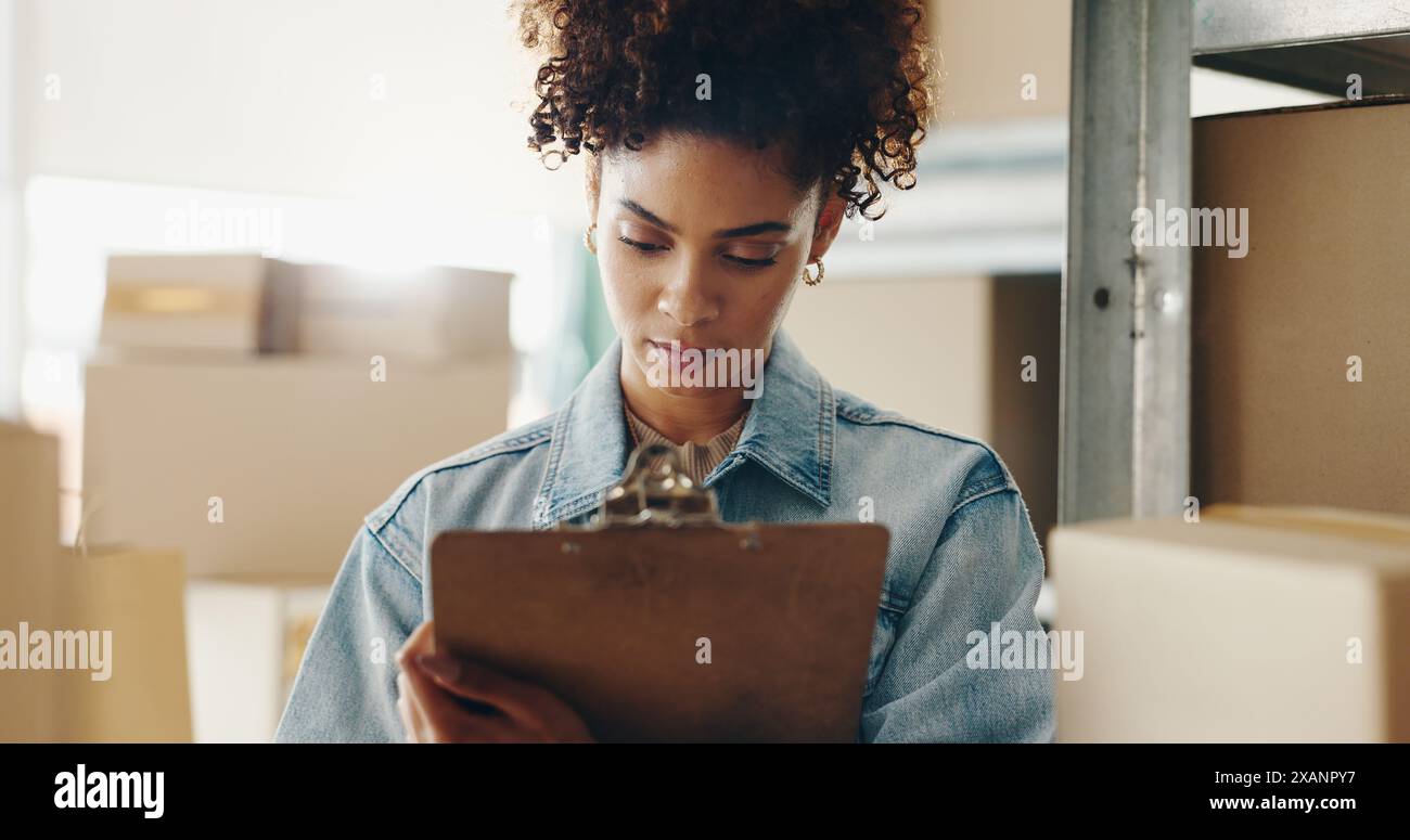Woman clipboard writing in warehouse hi-res stock photography and ...