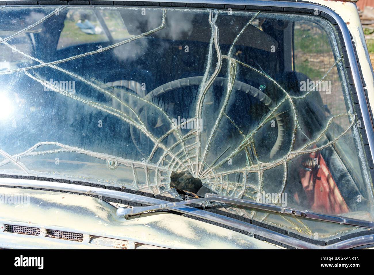 Close-up front view of a weathered vintage car with a severely ...