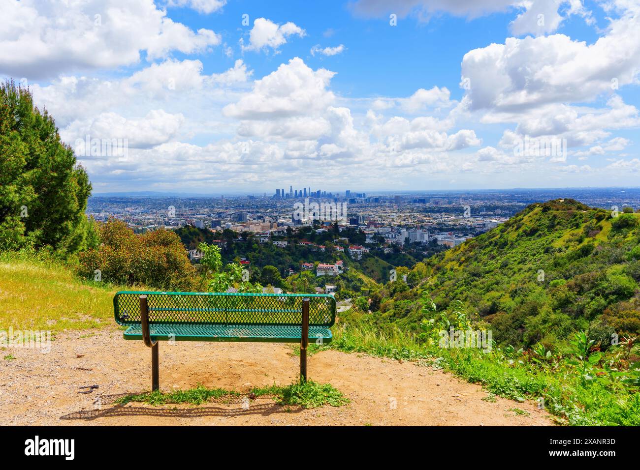 Panoramic view from Runyon Canyon, featuring a solitary green bench on ...