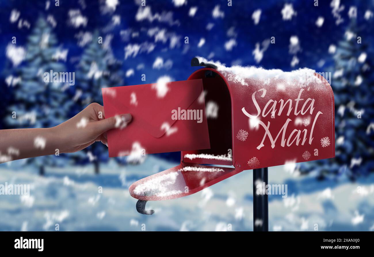 Woman putting letter to Santa Claus into mail box under falling snow ...