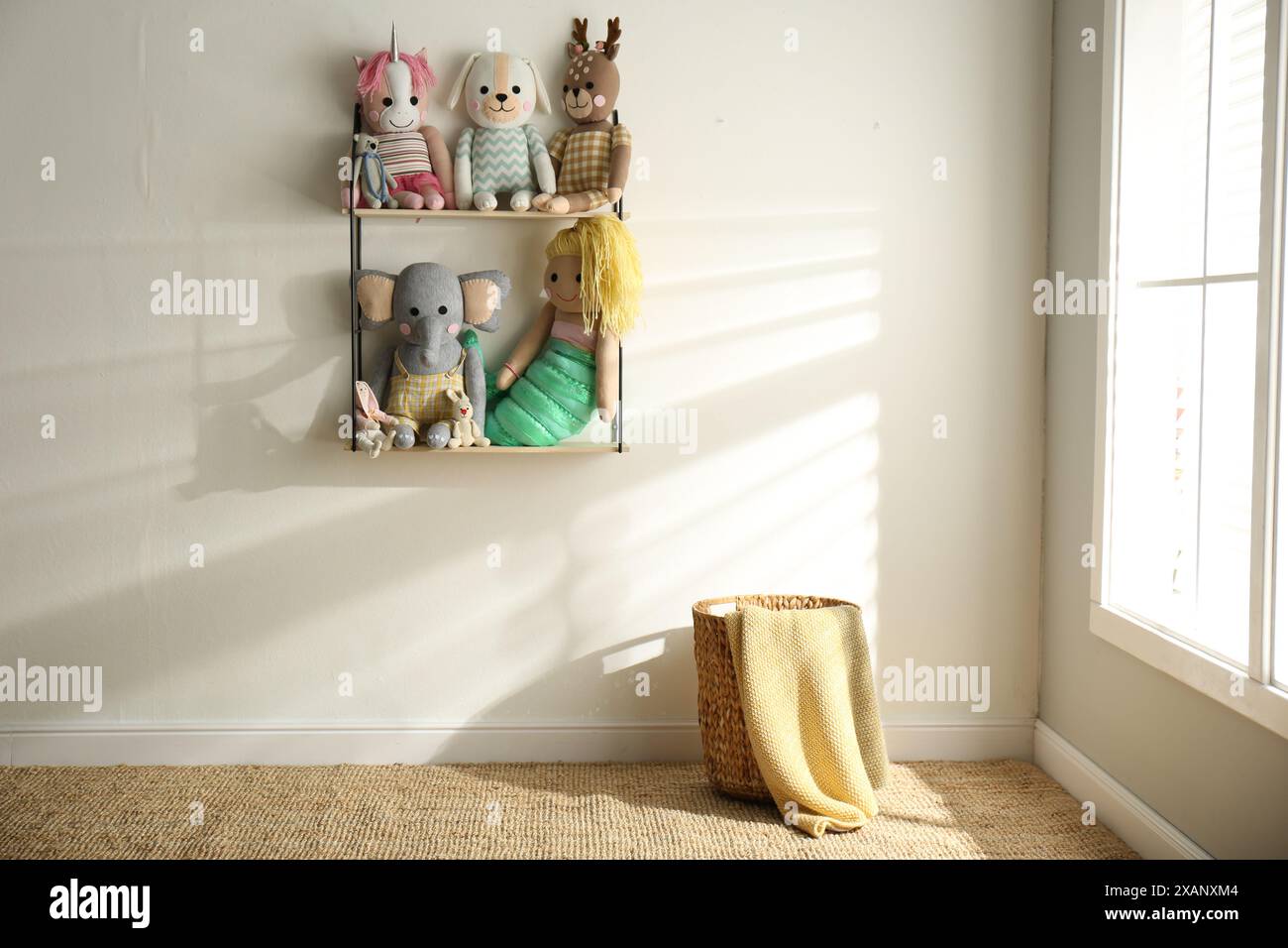 Shelf with cute toys on light wall indoors. Baby room interior element ...