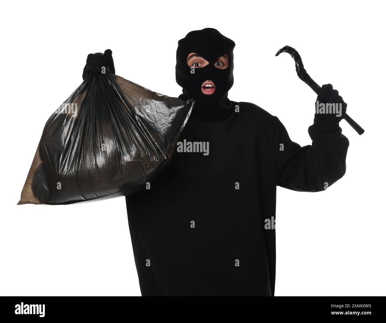 Emotional thief in balaclava with crowbar and bag raising hands on ...