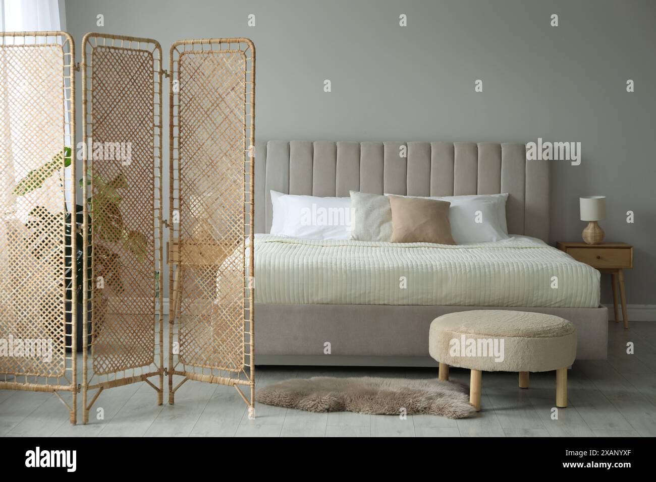 Folding screen and comfortable bed in bedroom. Interior design Stock ...