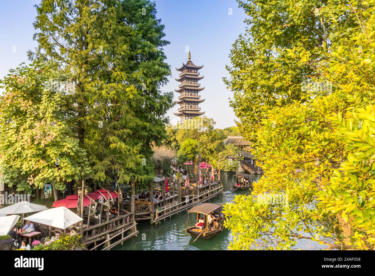 Wooden boat going to the Bailian temple pagoda in Wuzhen, China Stock ...