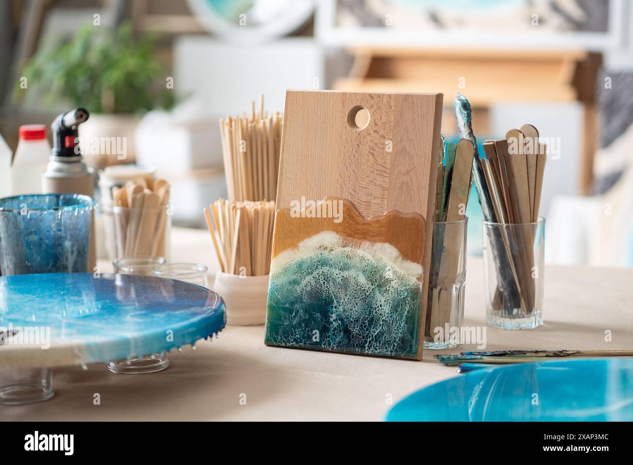 Artist workbench creating paintings artworks from epoxy resin. Table ...
