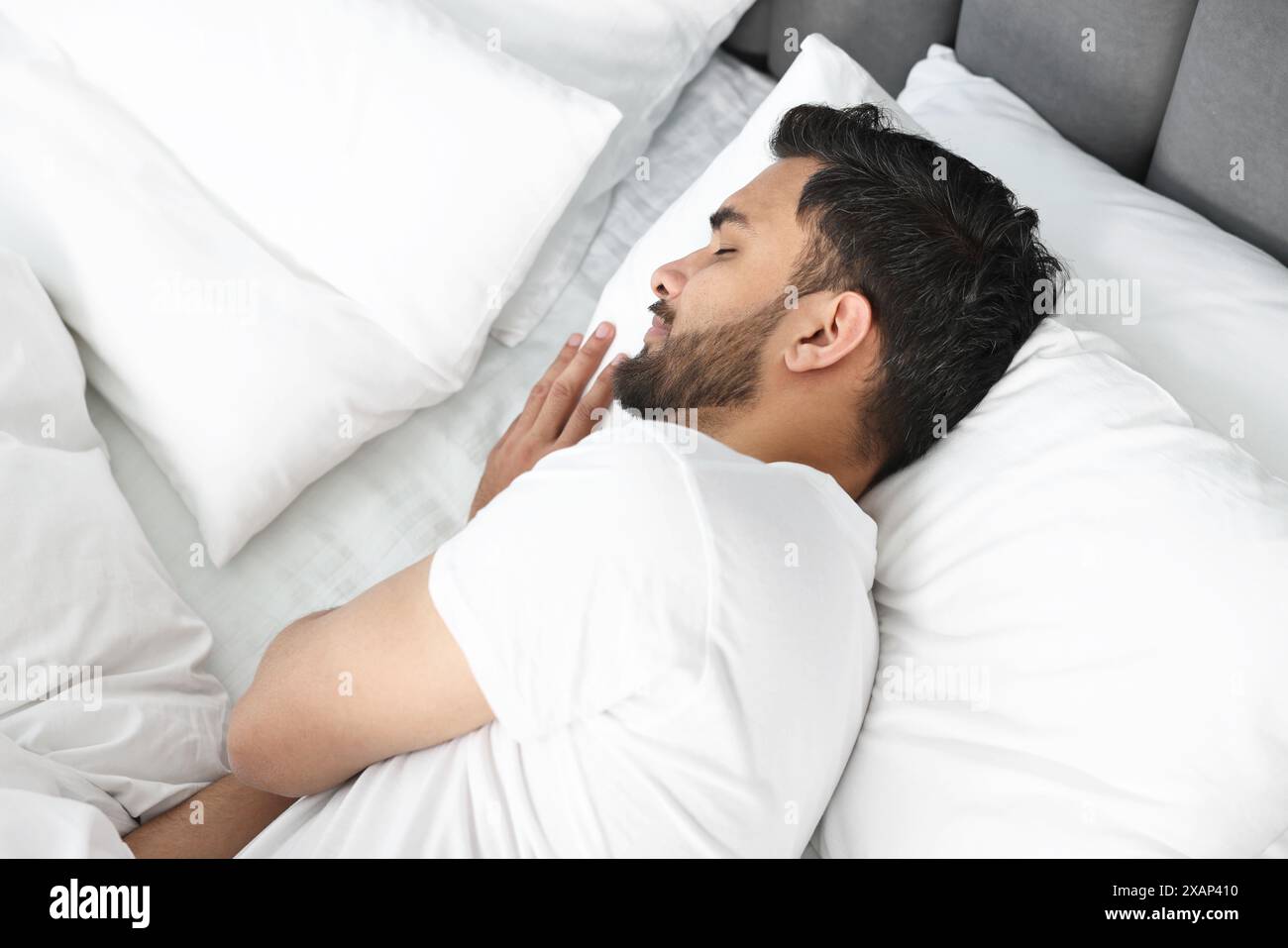 Handsome man sleeping on bed at morning Stock Photo - Alamy