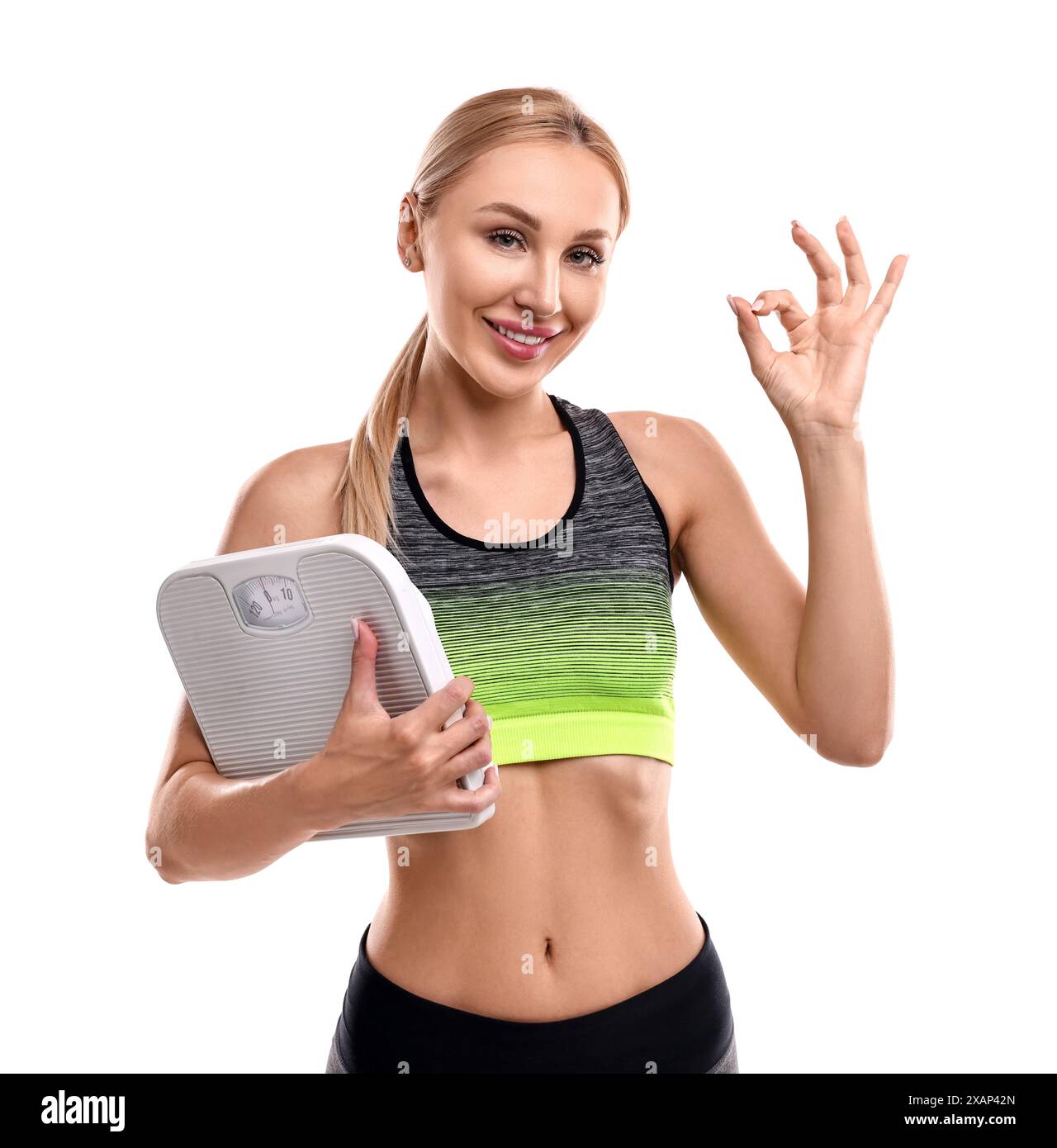 Happy woman with floor scale showing ok gesture on white background ...