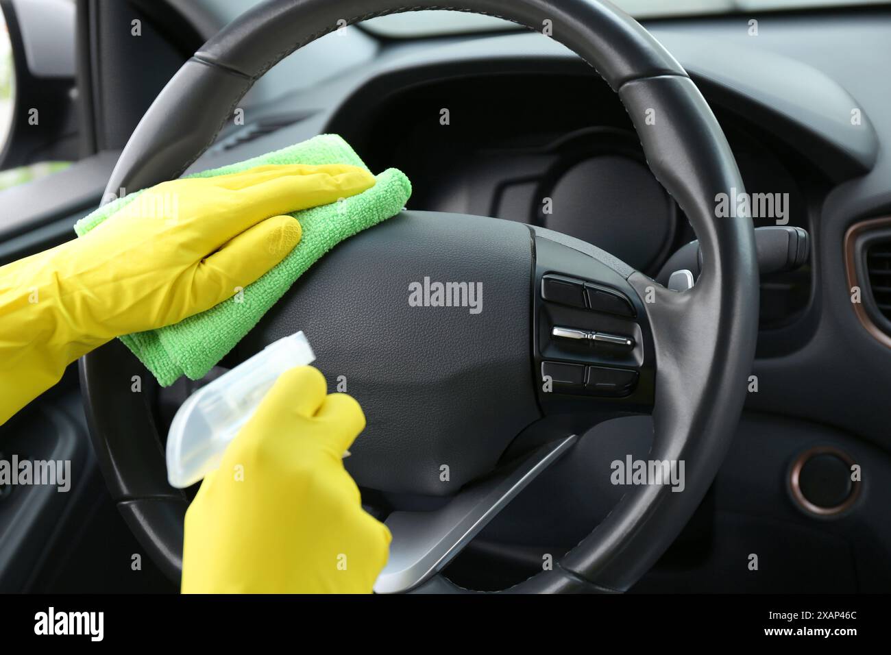 Woman cleaning steering wheel with rag in car, closeup Stock Photo - Alamy