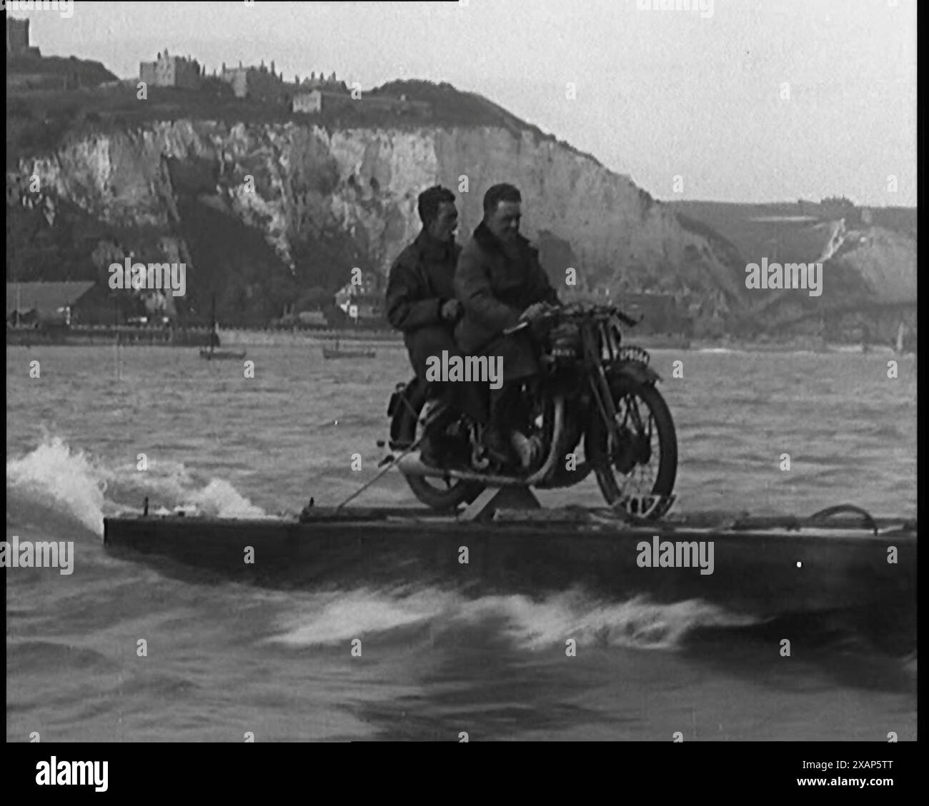 Two Male Civilians Riding a Motorcycle on a Float Across the English ...