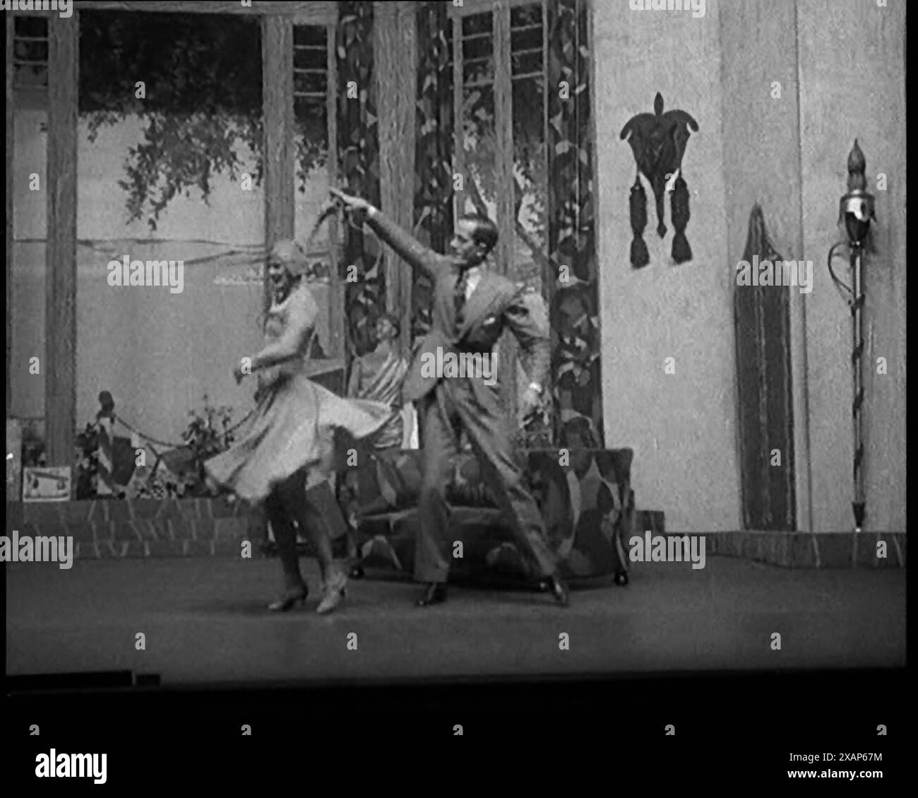 Scene from a Stage Show: Male and Female Civilian Dancing on a Stage in ...