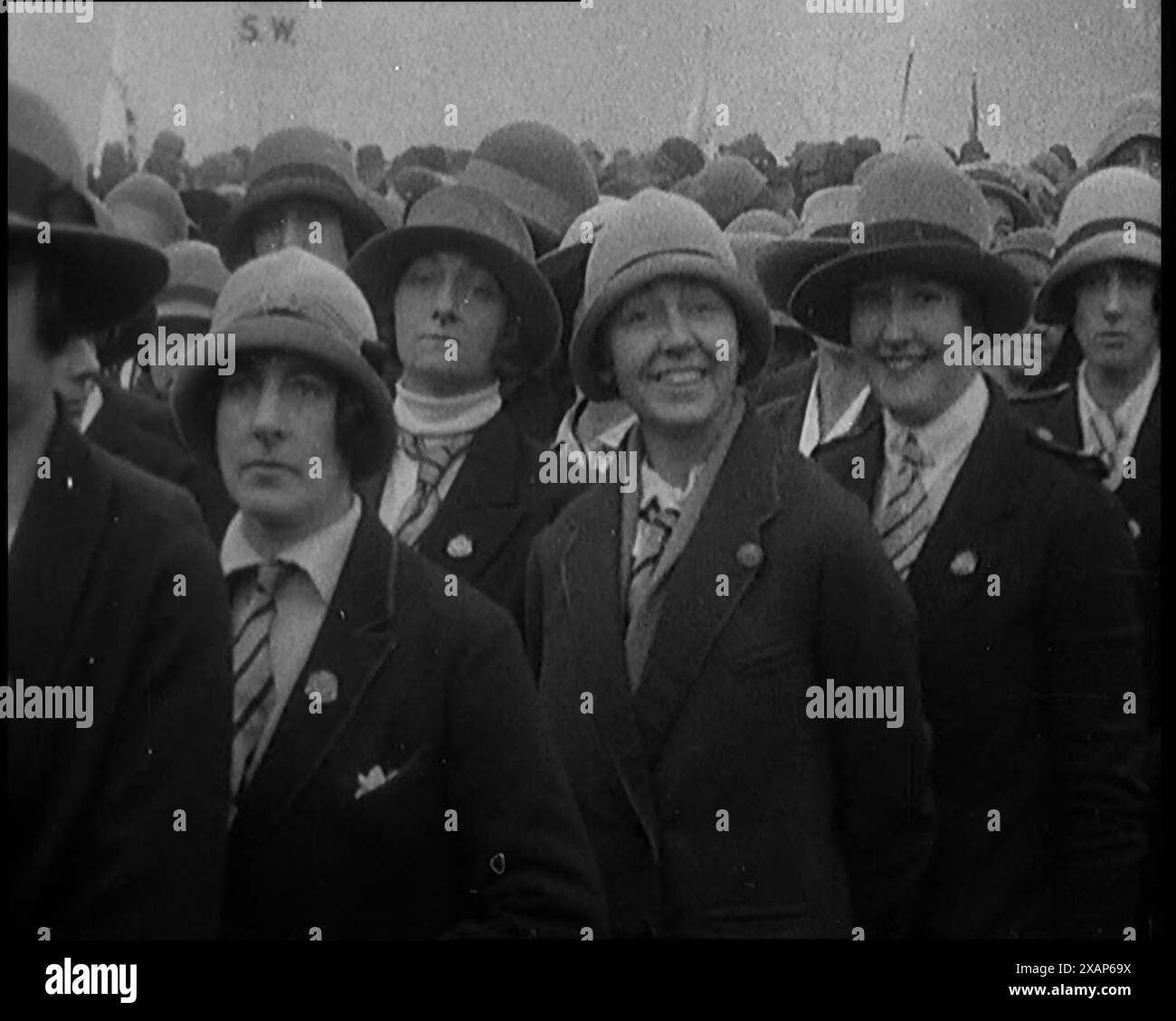 A Group of Female Civilians Wearing Ties, Coats and Hats at a Political ...