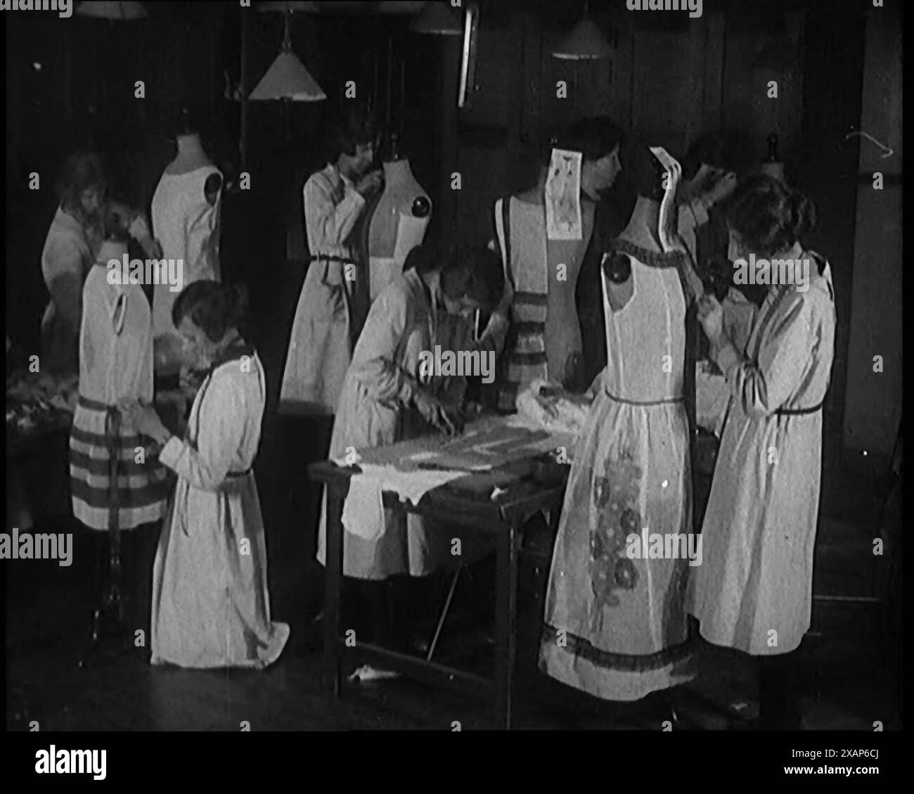 Young Female Civilians Sewing Dresses on Mannequins in an Arts Class ...