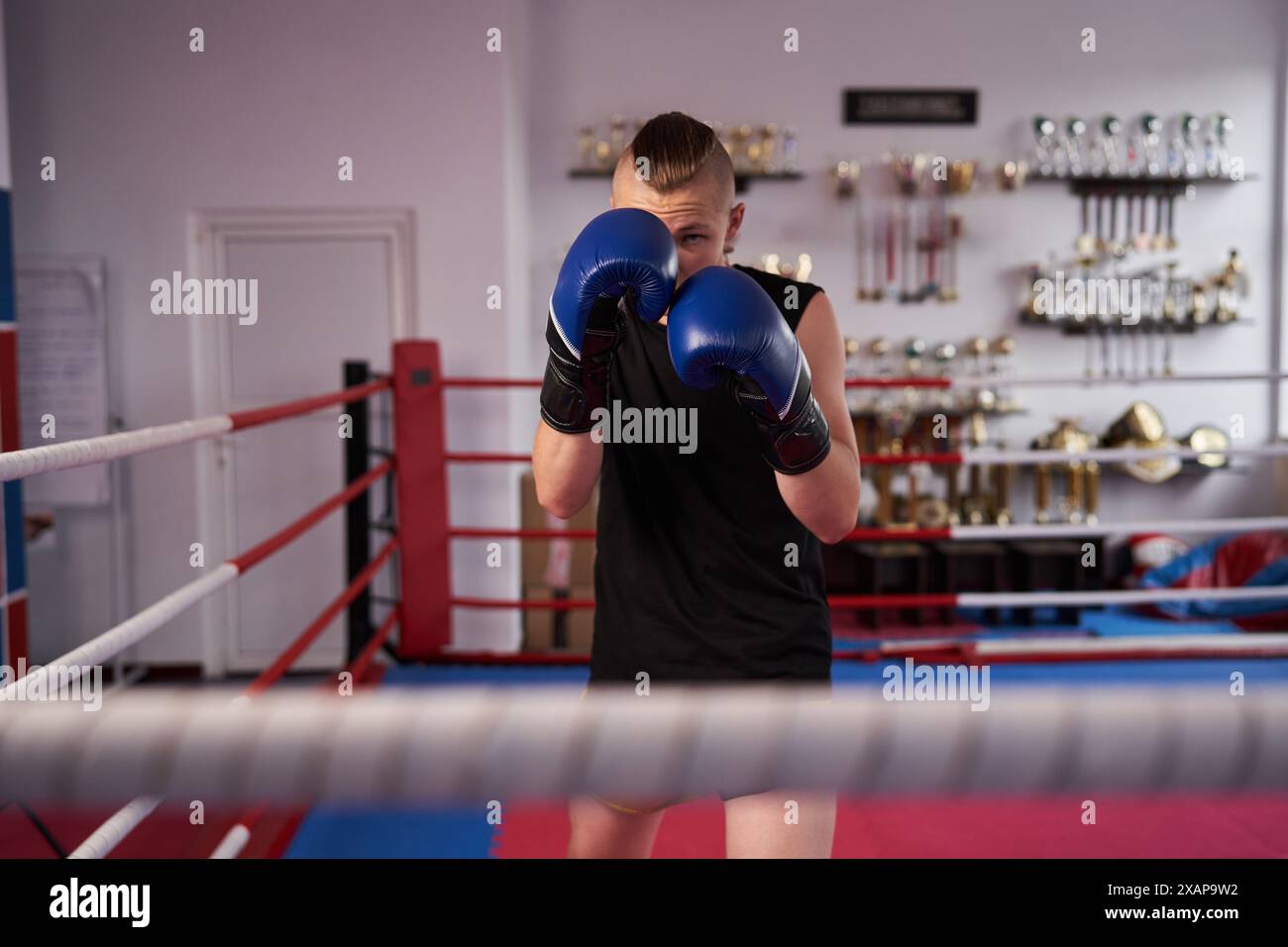 Young teen boxer training by shadow boxing in the ring Stock Photo - Alamy