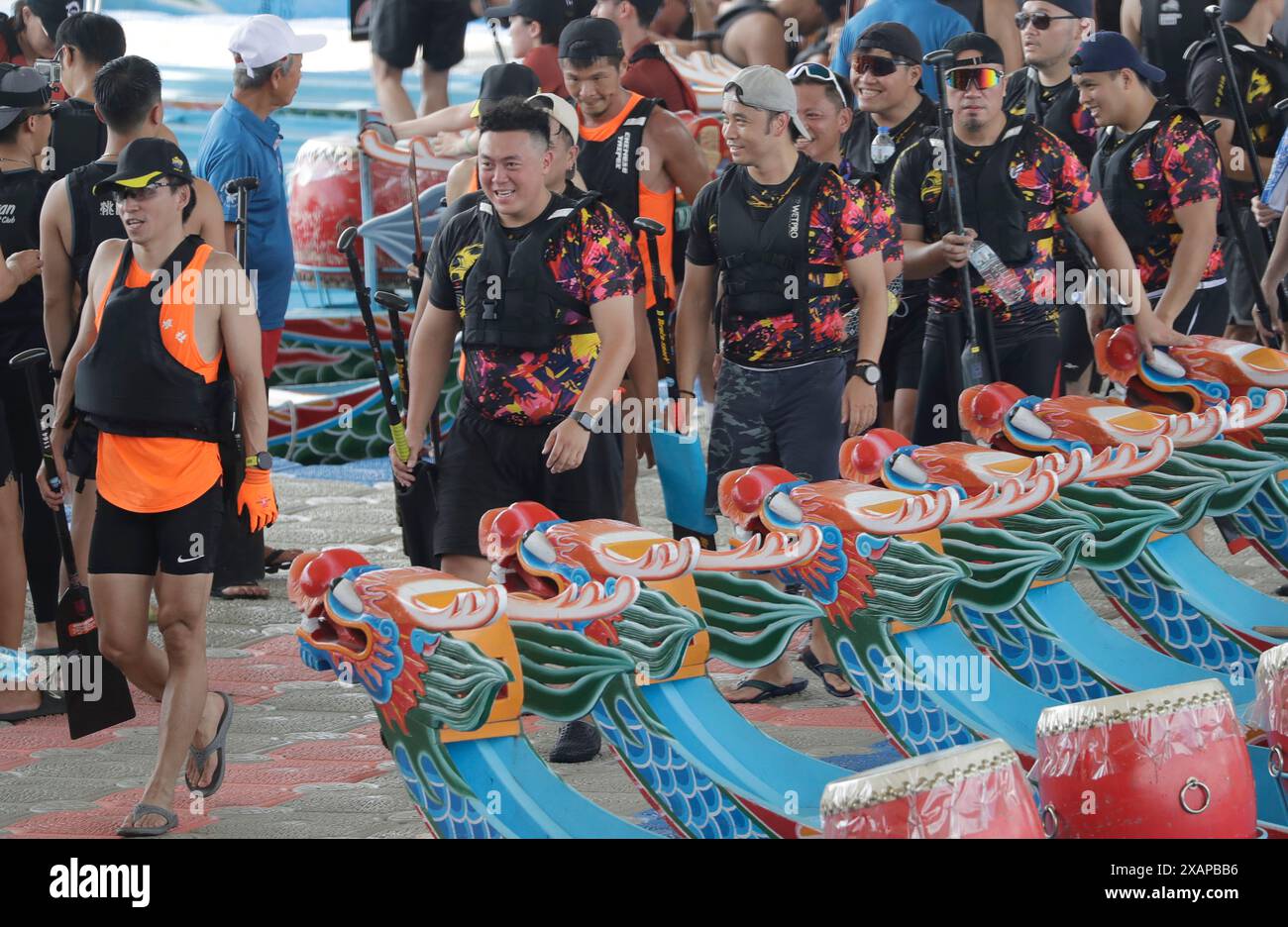 Dragon boat crew members cheer during a traditional Chinese dragon boat ...