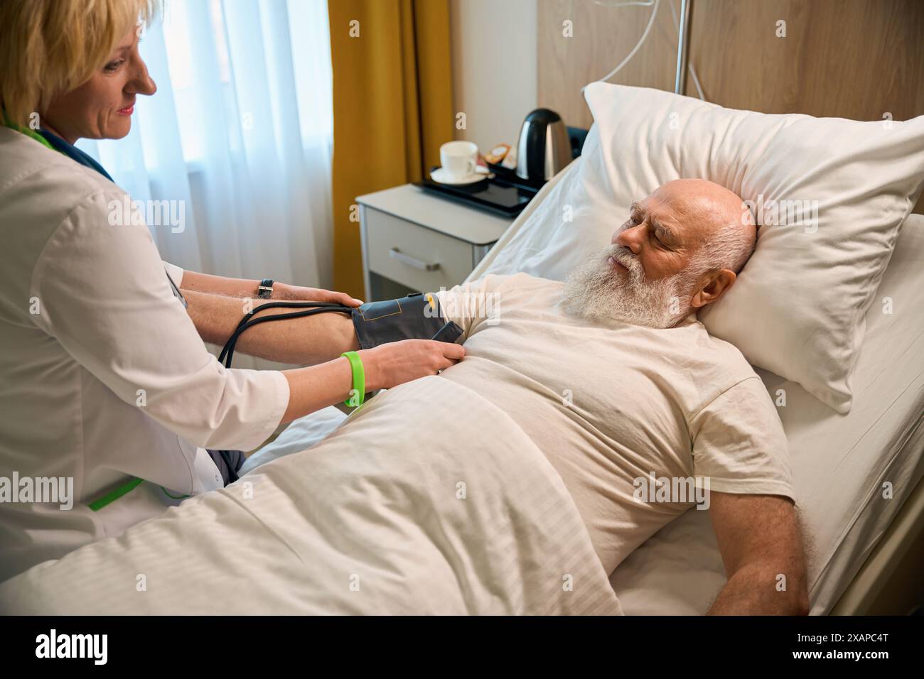 Old bald patient has his blood pressure measured Stock Photo - Alamy