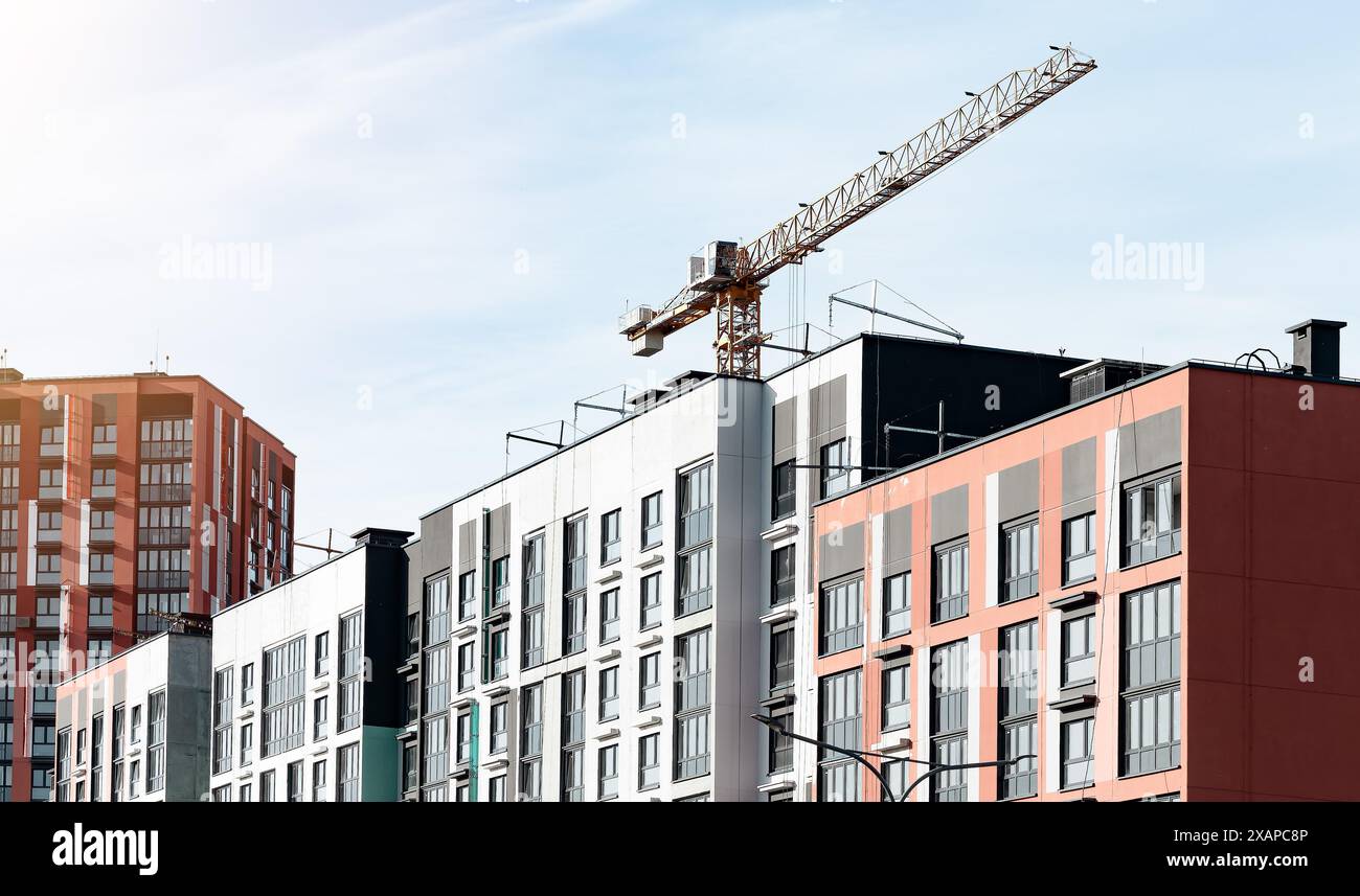 Construction cranes and new condo buildings in urban neighborhoods ...