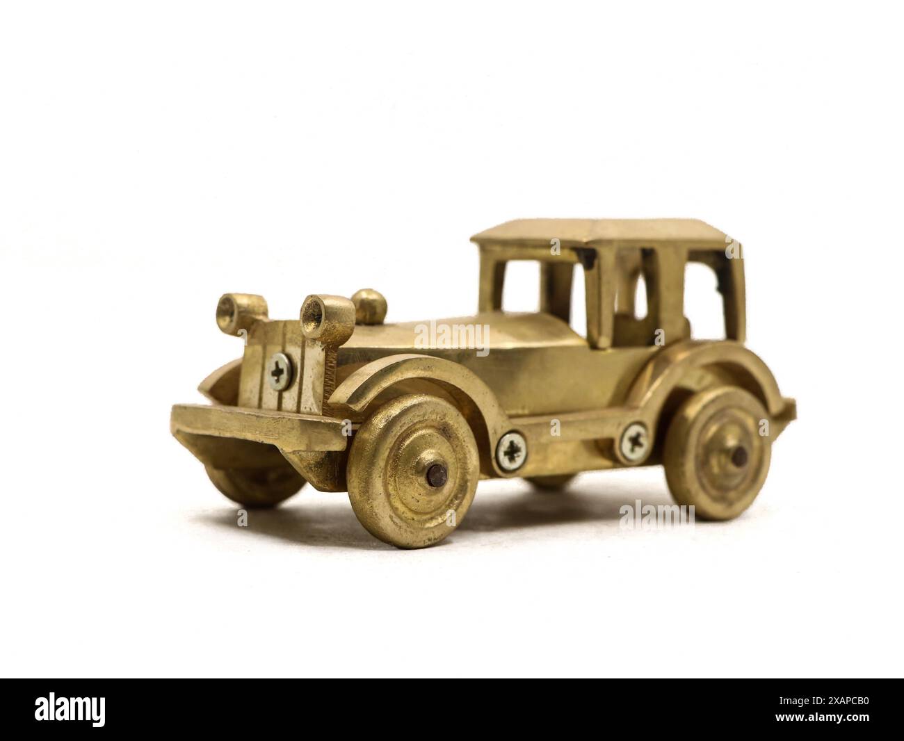 antique toy model of a vintage car made in golden metal isolated Stock ...