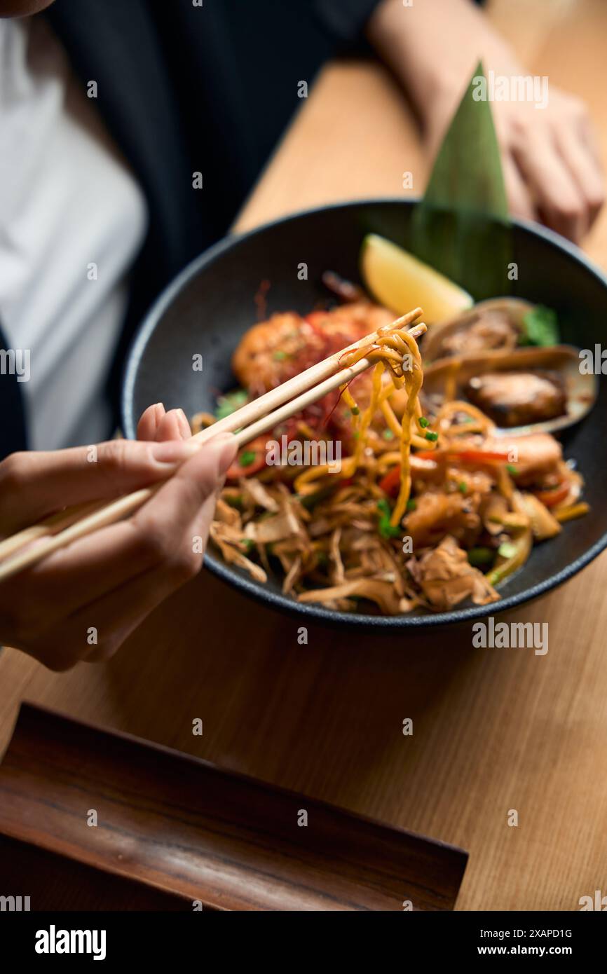 Woman cooking noodles seafood hi-res stock photography and images - Alamy
