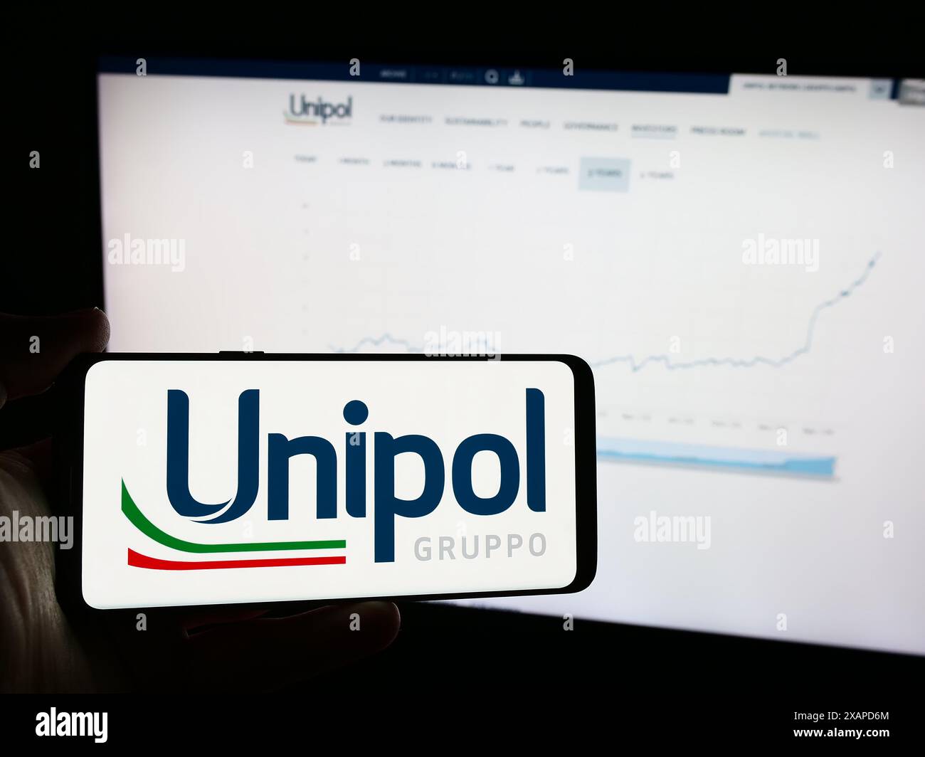 Person holding mobile phone with logo of Italian financial services ...