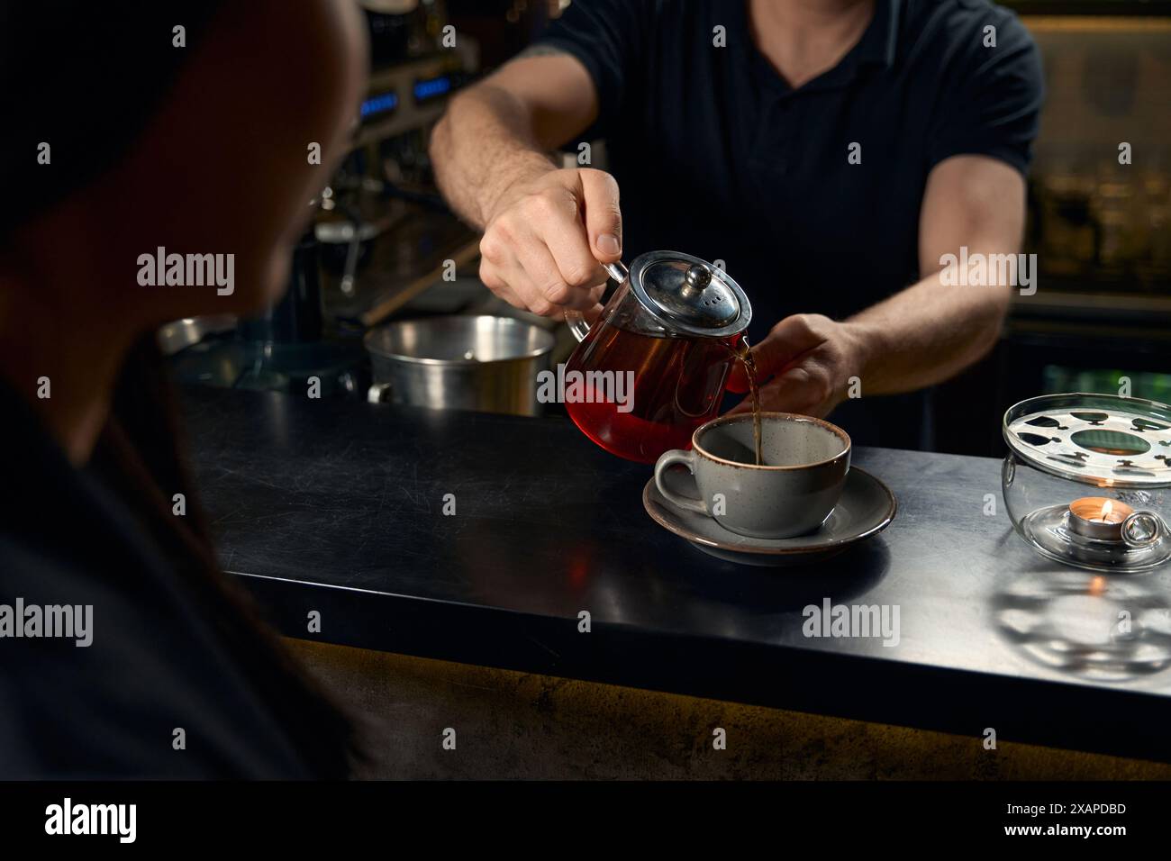 Waiter pouring black tea hi-res stock photography and images - Alamy