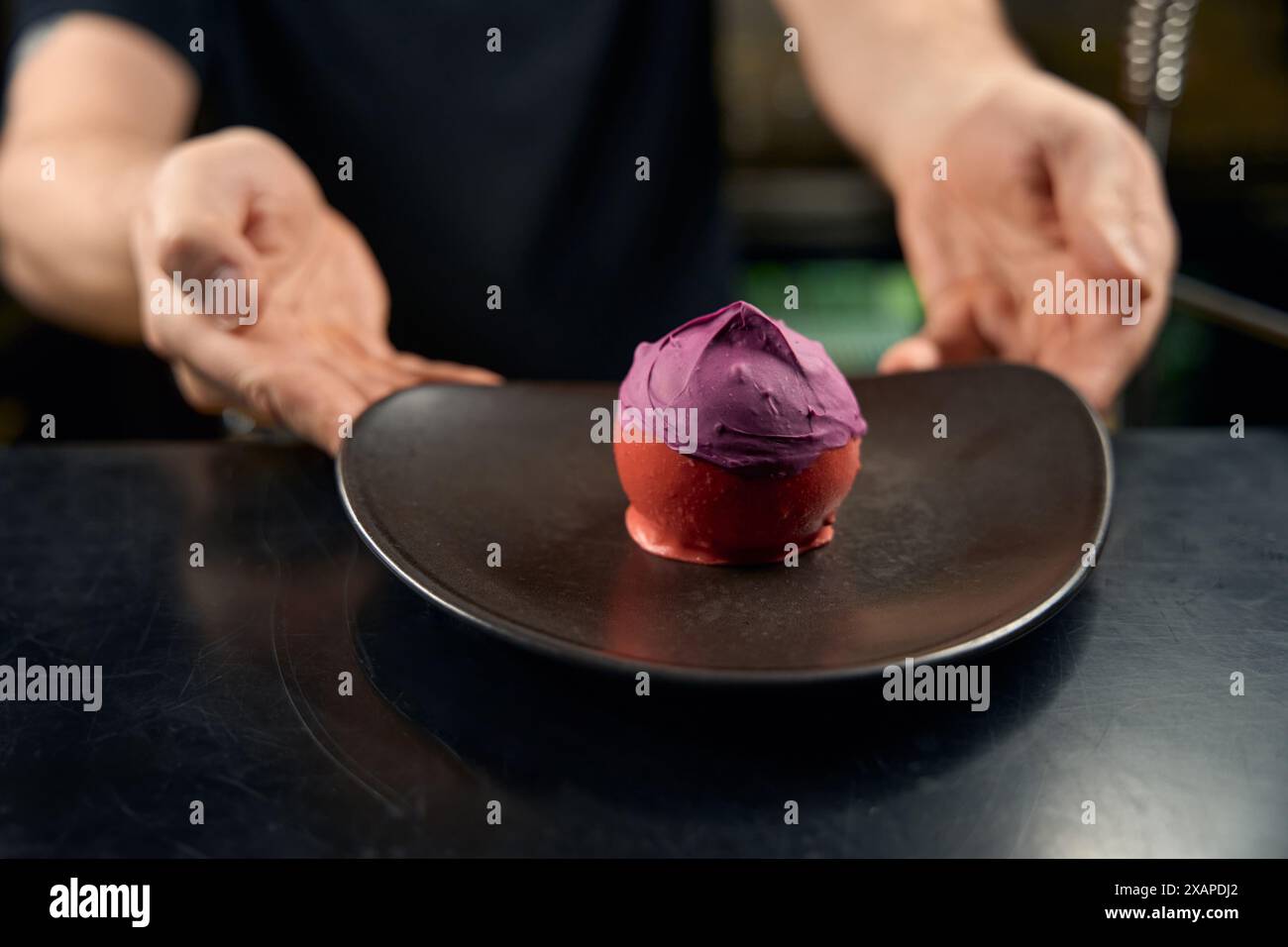 The waiter serving the round dessert in chocolate Stock Photo - Alamy