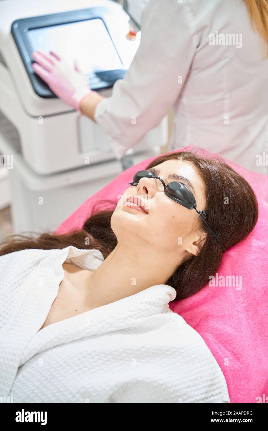 Woman being prepared for intense pulsed light treatment Stock Photo - Alamy