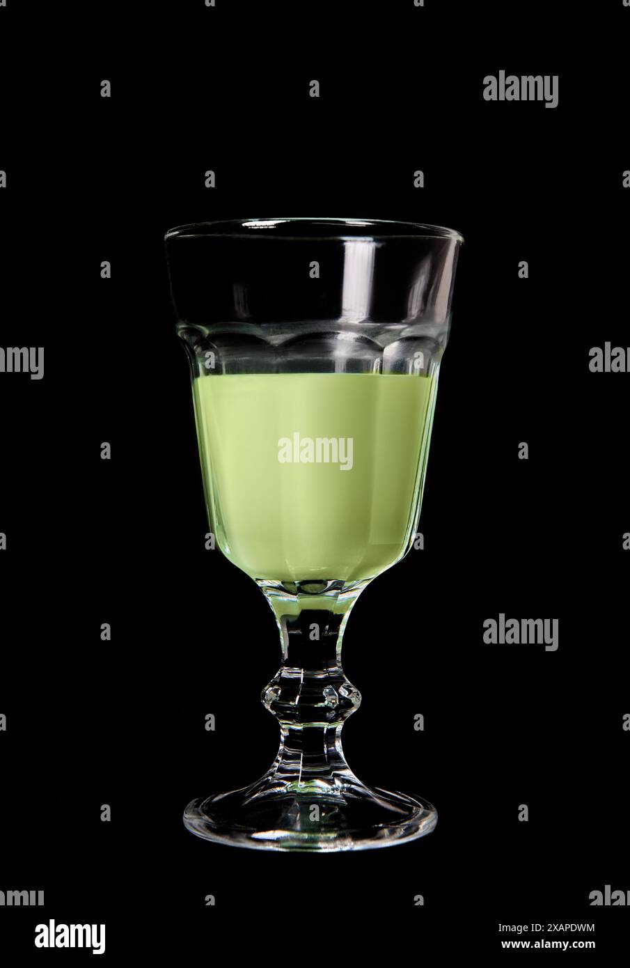 Glass of absinthe on a black background Stock Photo - Alamy
