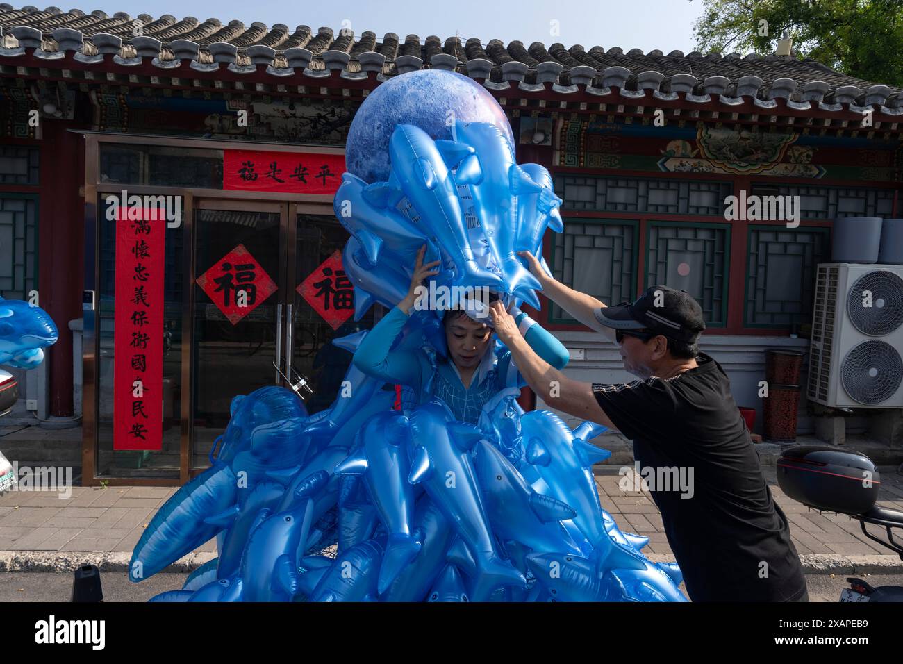 Chinese artist Kong Ning wears her latest creation titled "Blue Fish ...