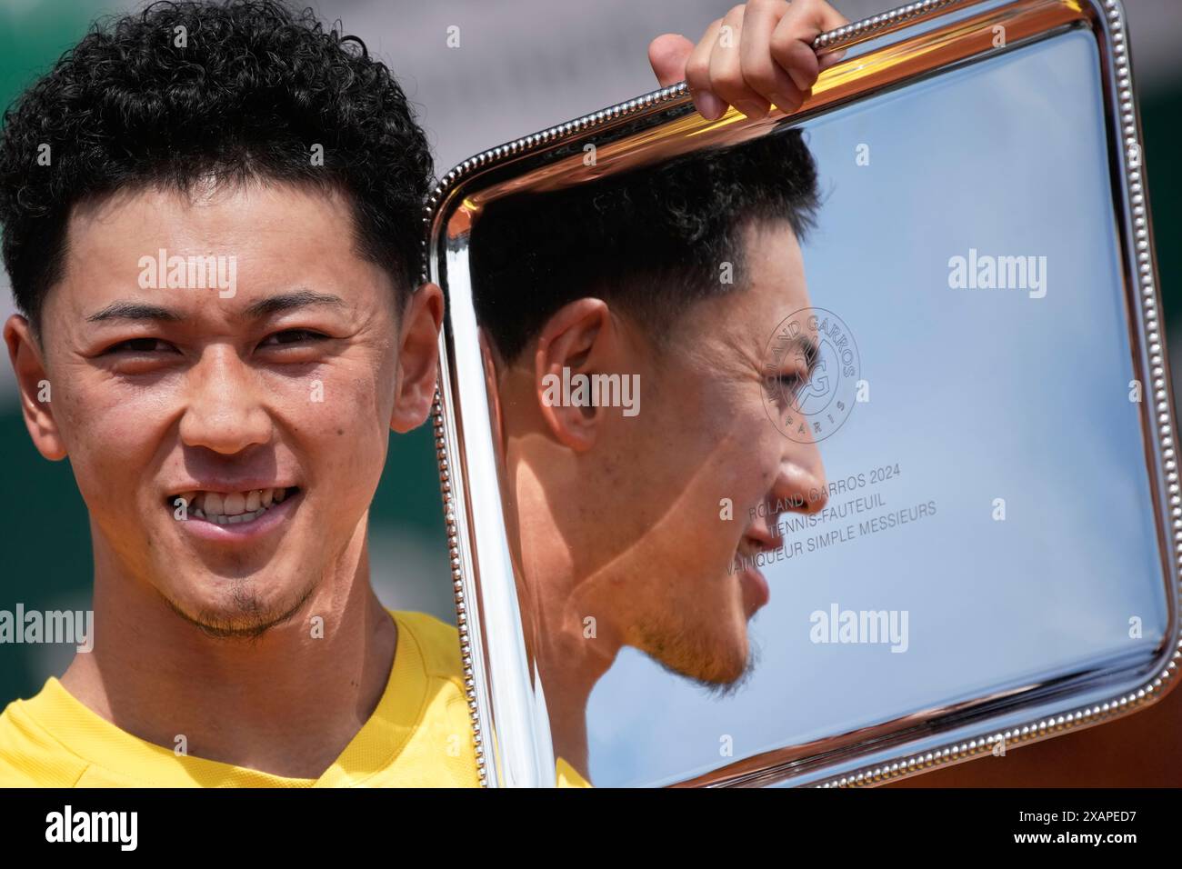 Japan's Tokito Oda holds the trophy after winning against Argentina's ...