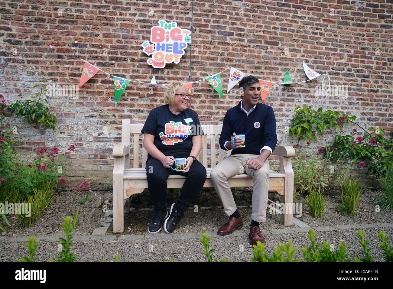 Prime Minister Rishi Sunak drinking a tea of tea whilst talking to ...