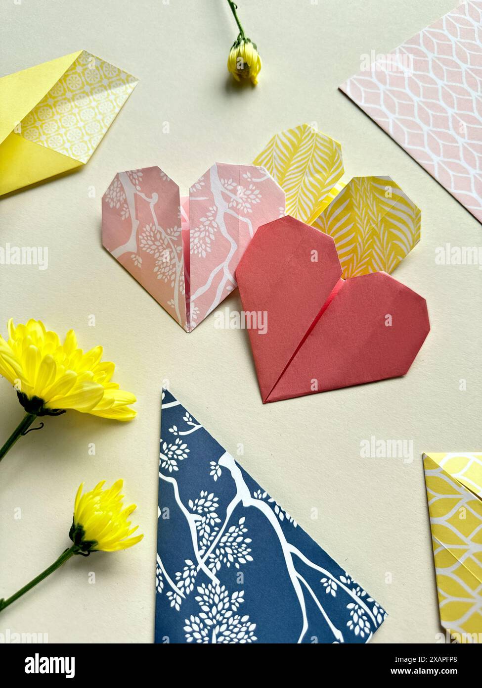 Colorful Origami Hearts in Varying Patterns Arranged Near Envelopes on ...